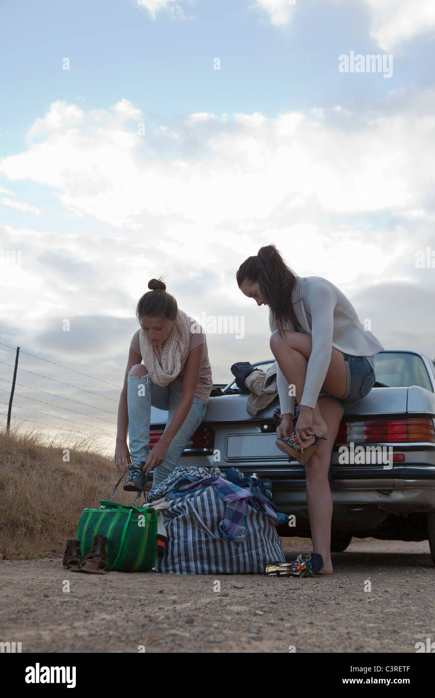Girls changing shoes Stock Photo - Alamy