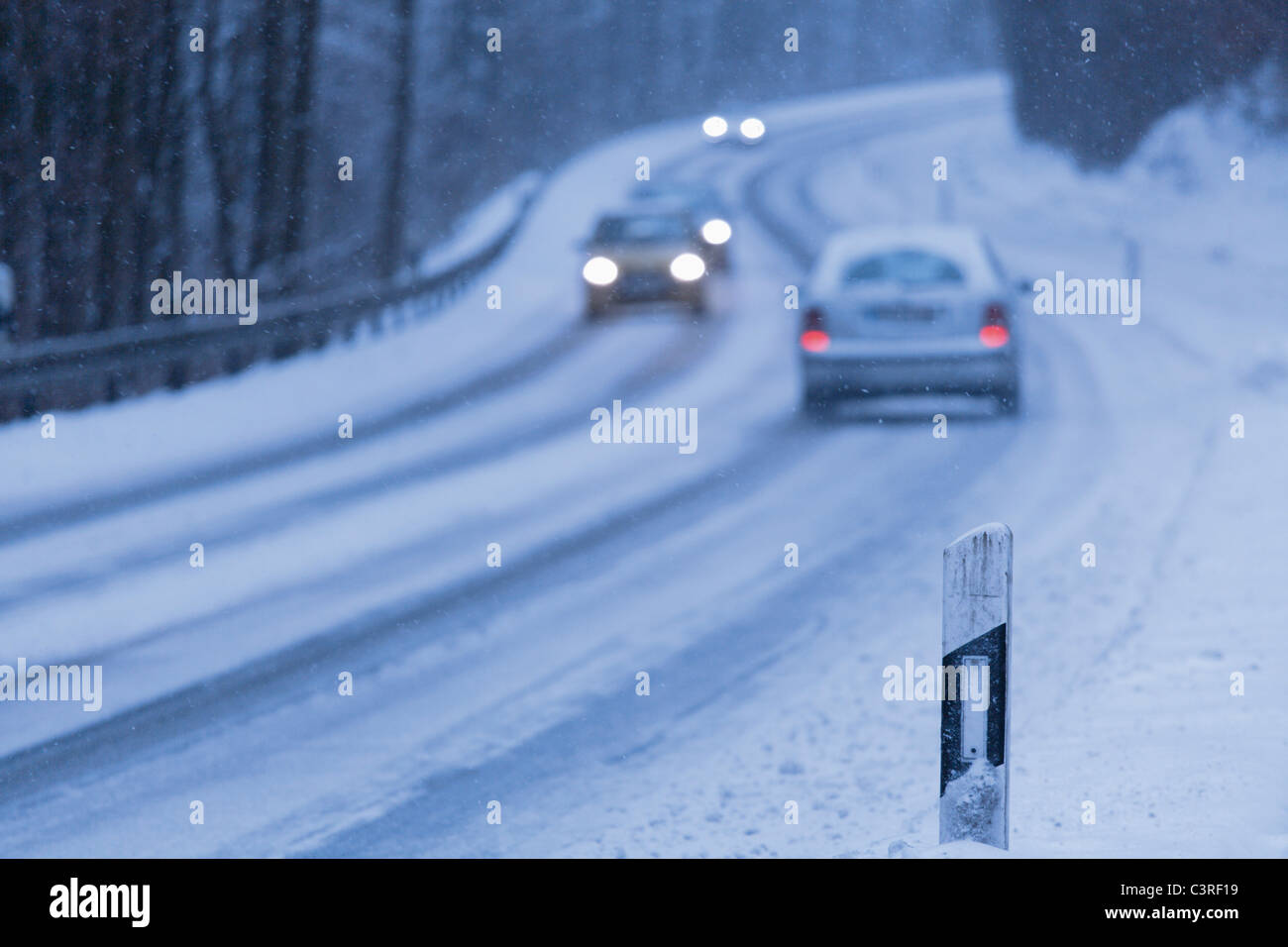 Germany, Bavaria, Schaeftlarn, cars on country road in winter Stock ...
