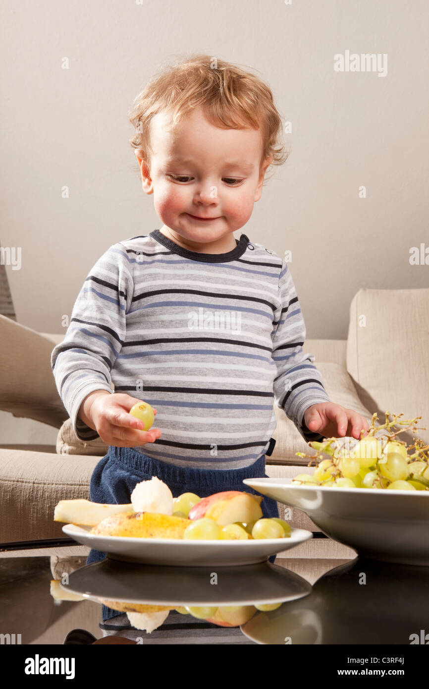 Little boy eating fruit Stock Photo - Alamy