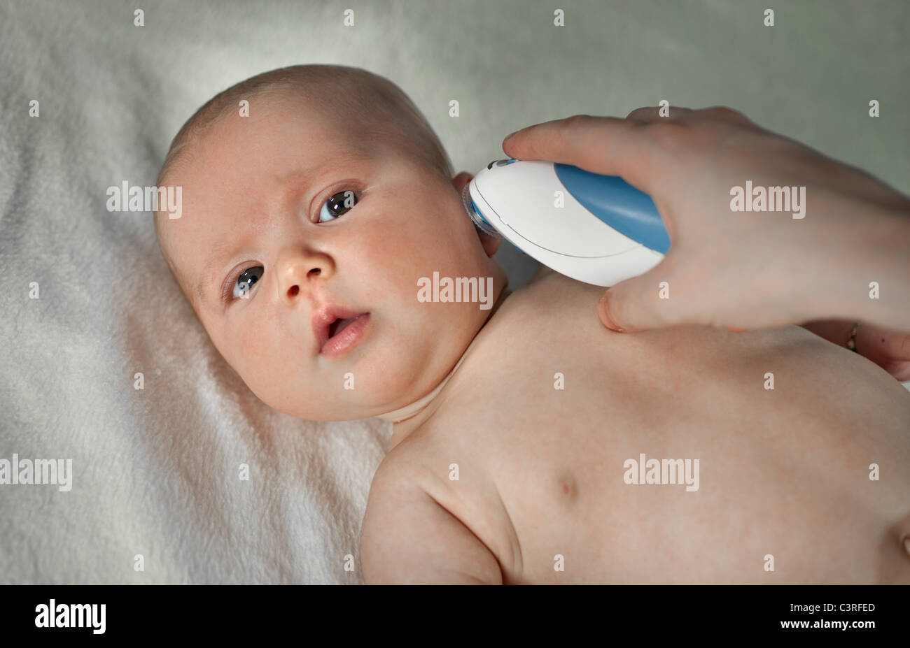 Mum checking temperature to her newborn Stock Photo - Alamy