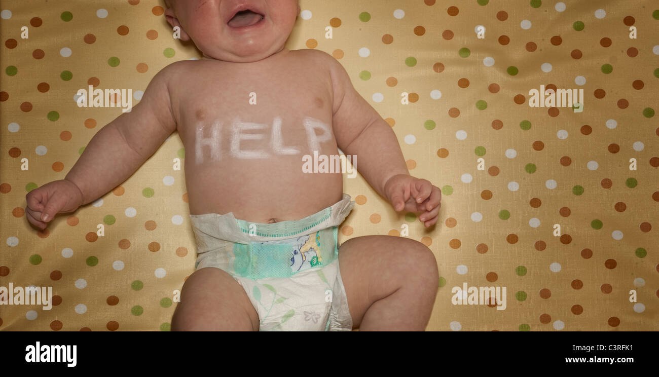 Newborn with help write on chest Stock Photo - Alamy