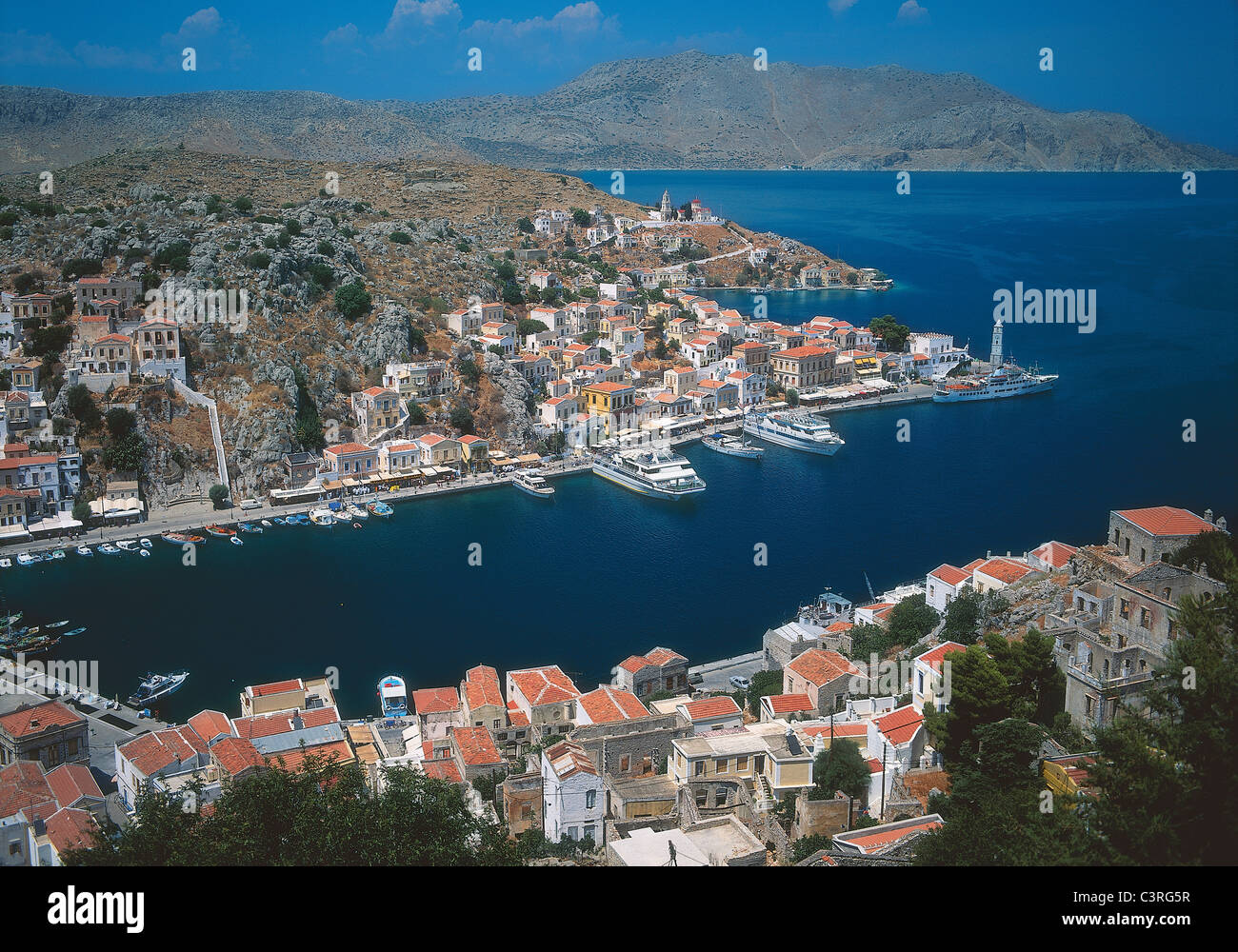 Greece, Symi, View of city with mountains in background Stock Photo - Alamy