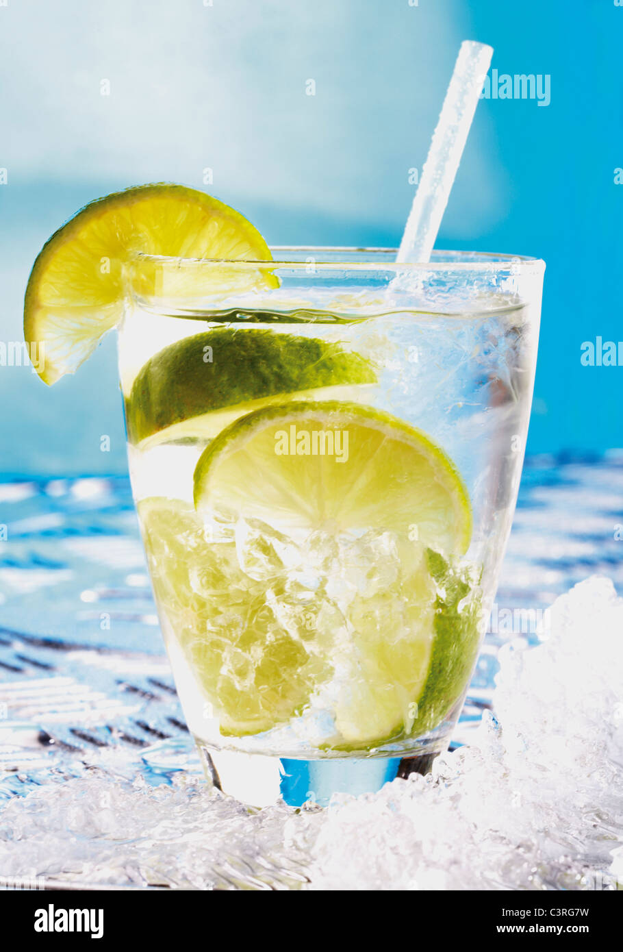 Glass of iced drink with slices of lime Stock Photo - Alamy