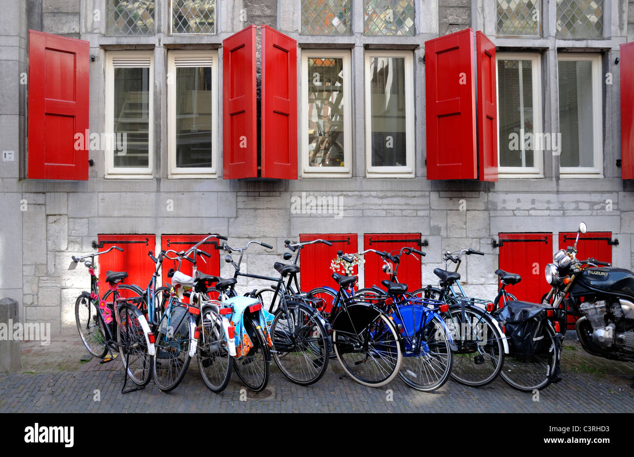 Utrecht, Netherlands. Windows with traditional red shutters / parked ...