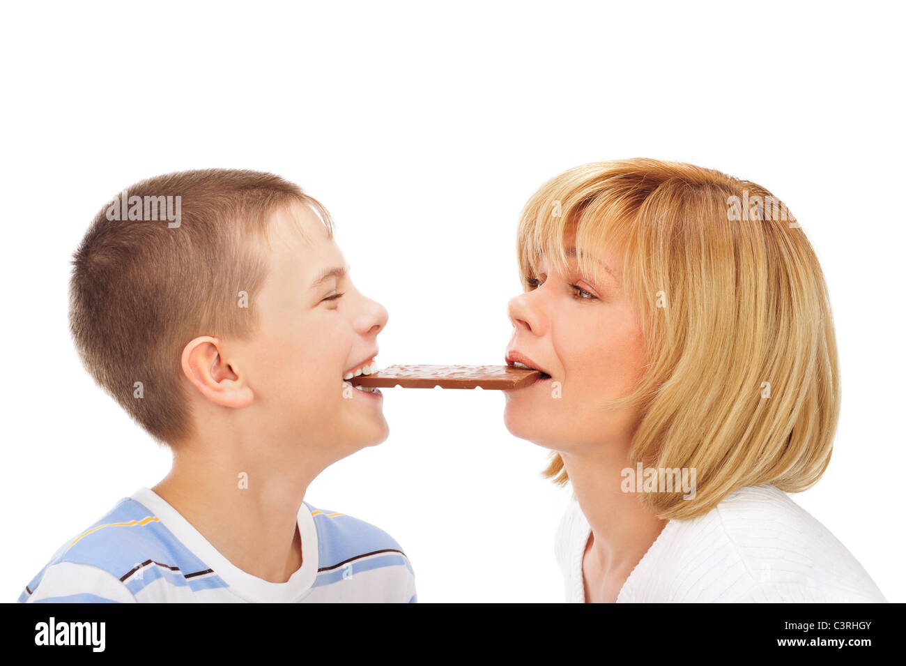 Portrait of happy european family of son and his mother eating ...