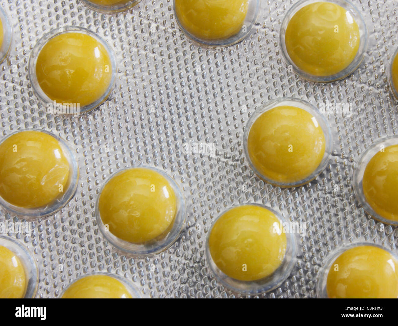 Many different tablets lie on a white background of yellow color Stock ...
