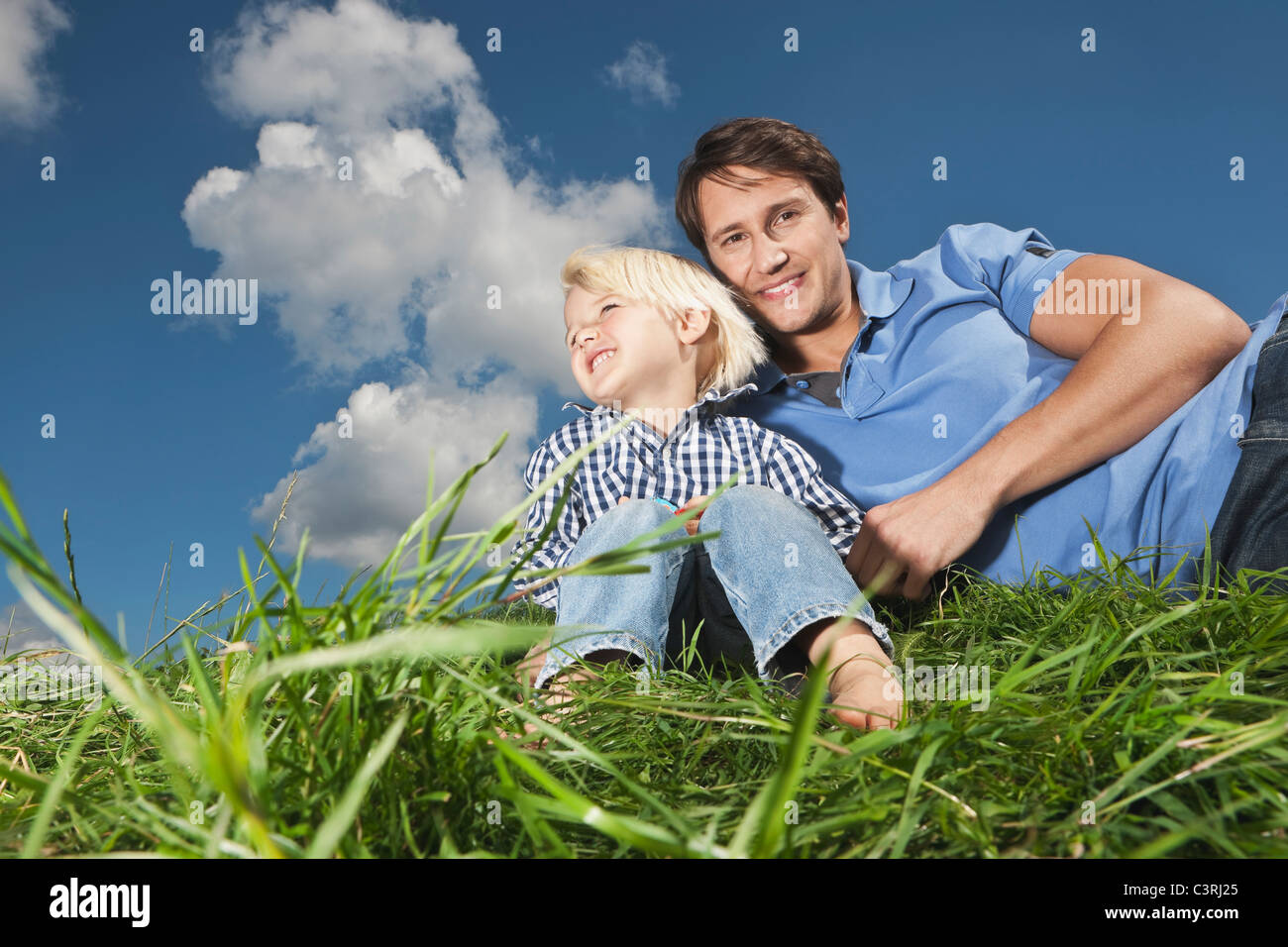 Germany, Cologne, Father with son (2-3 Years) on grass, smiling Stock ...