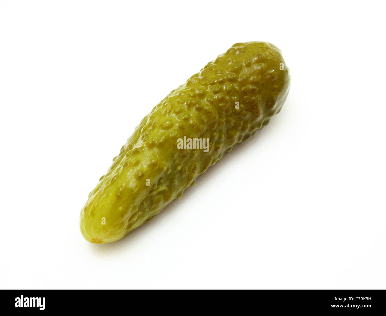 The green tasty pickle lies on a white background Stock Photo - Alamy