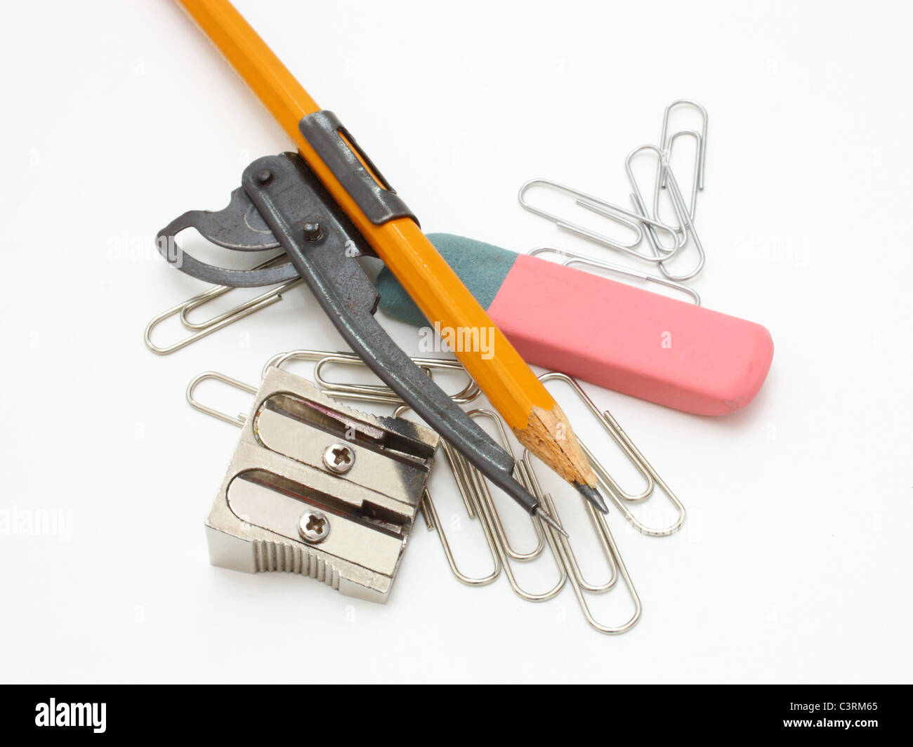 shot of eraser, pencil and pencil metal double sharpener on a white ...