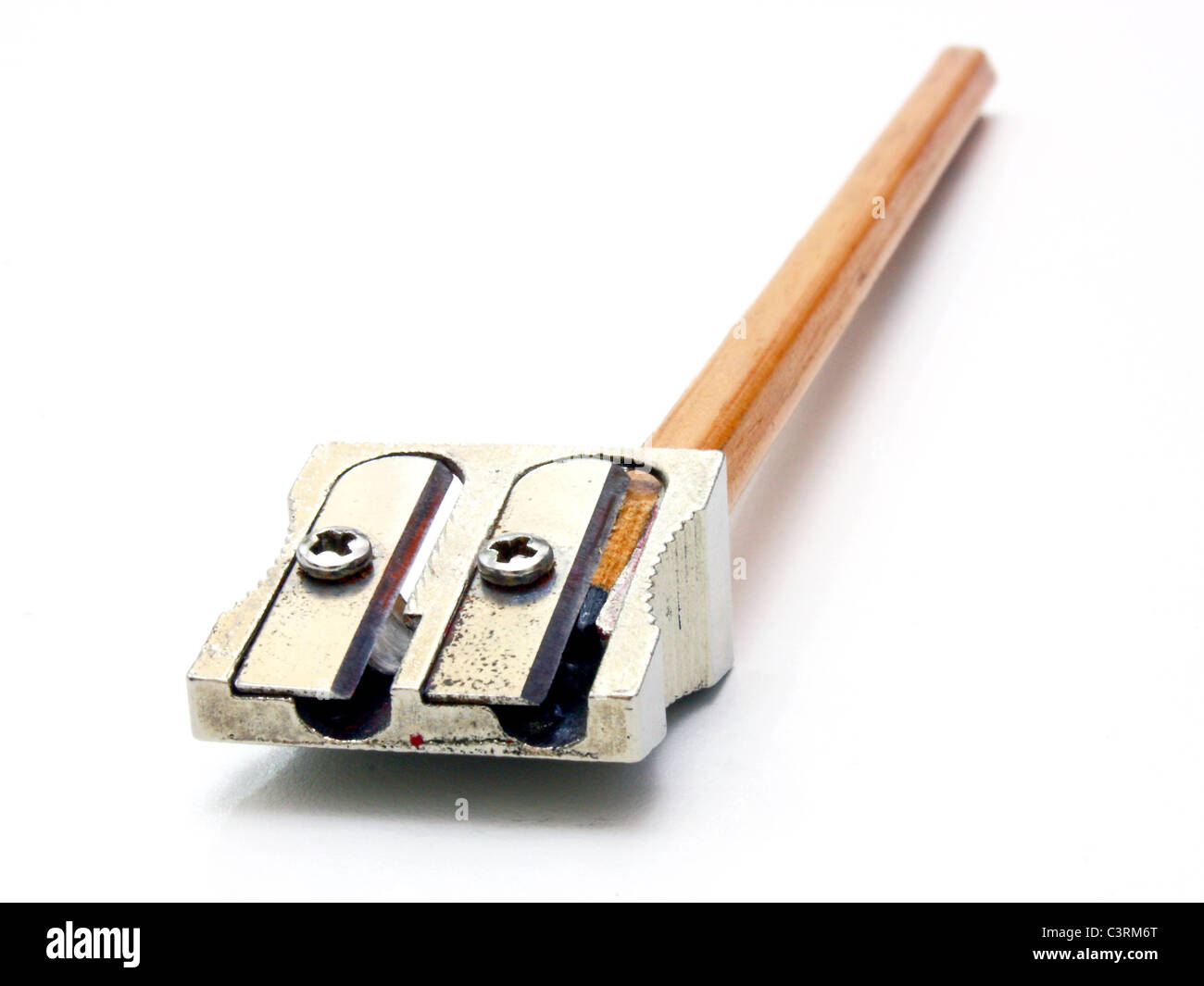 shot of eraser, pencil and pencil metal double sharpener on a white ...