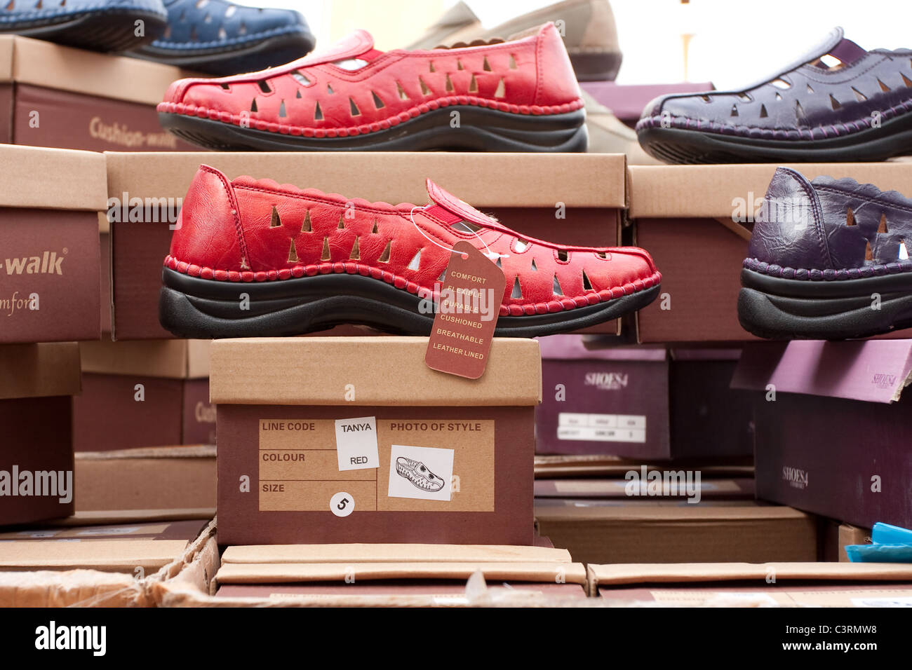Colorful leather shoes for sale at a market stall Stock Photo - Alamy