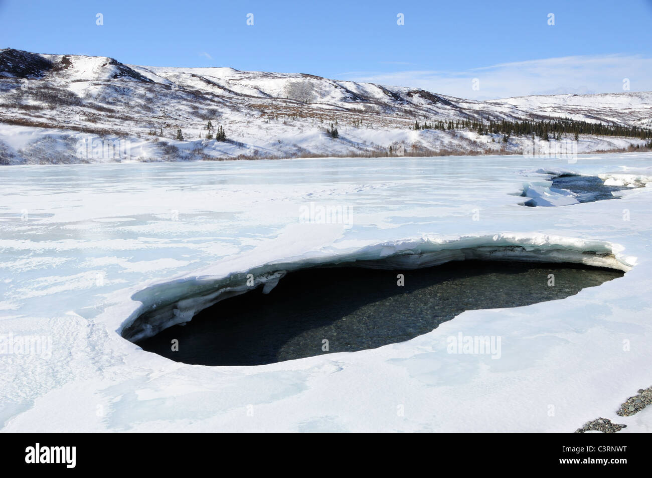 Hole in Alaska River Ice during Spring Breakup Stock Photo - Alamy