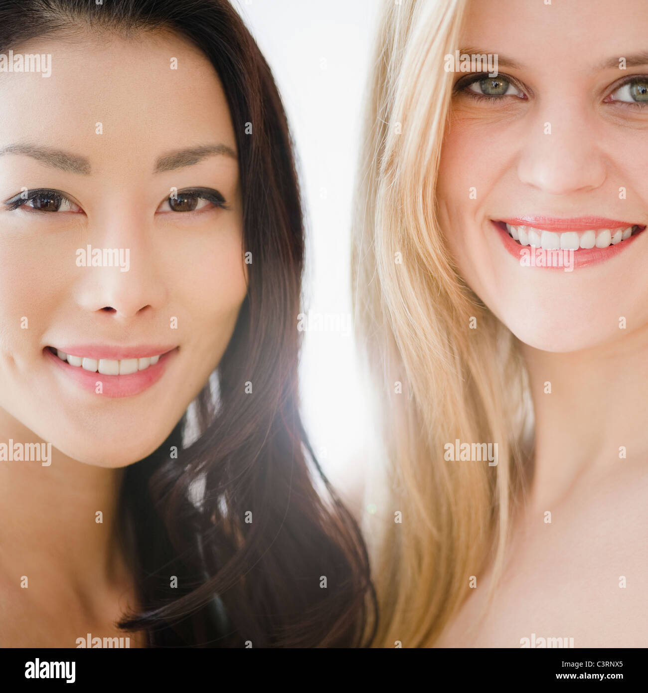 Smiling friends standing together Stock Photo - Alamy