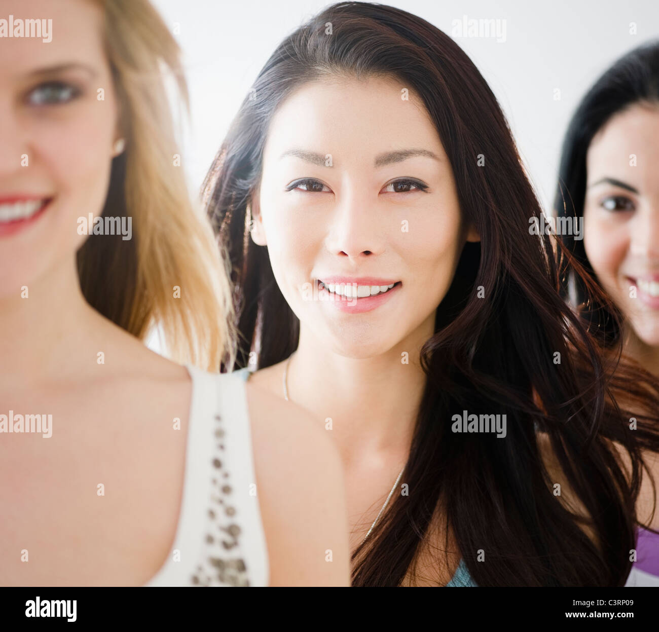 Smiling friends standing together Stock Photo - Alamy