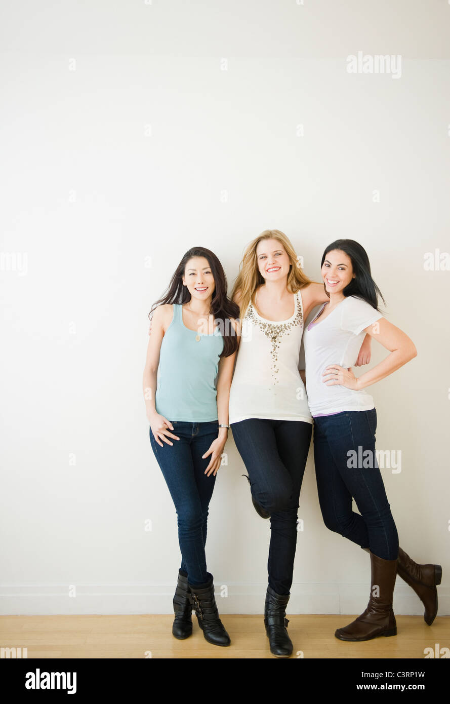 Smiling friends standing together Stock Photo - Alamy