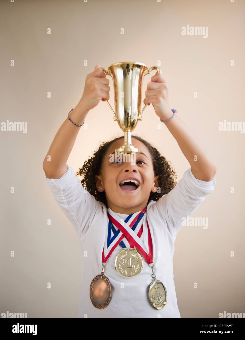 African American girl holding up trophy Stock Photo - Alamy