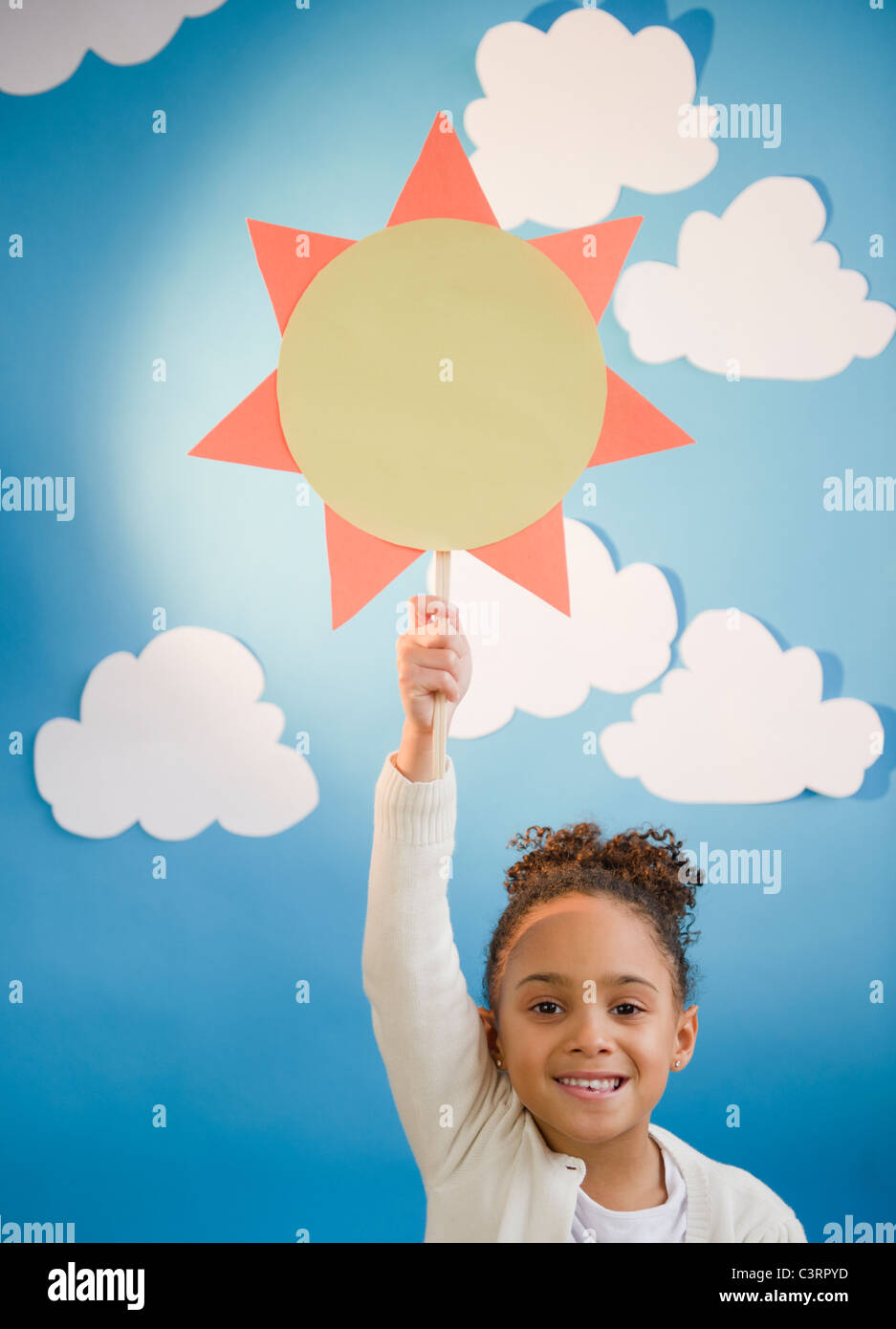 African American girl holding up paper sun Stock Photo - Alamy