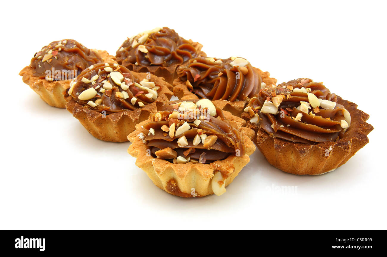 Pie a basket with chocolate condensed milk and nuts on a white ...