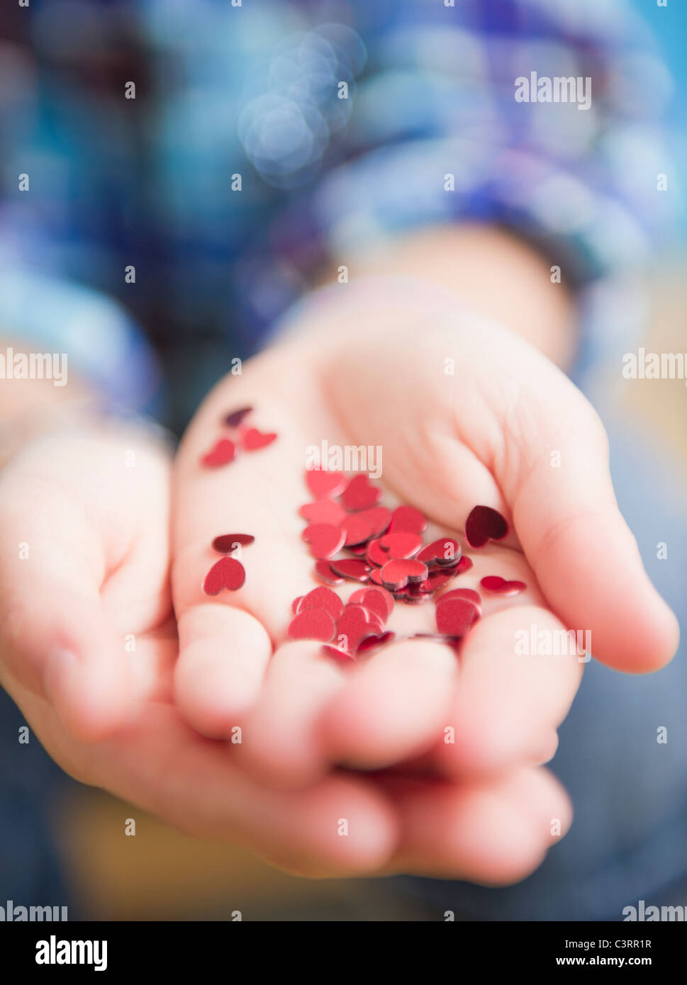 African American girl holding handful of hearts Stock Photo - Alamy