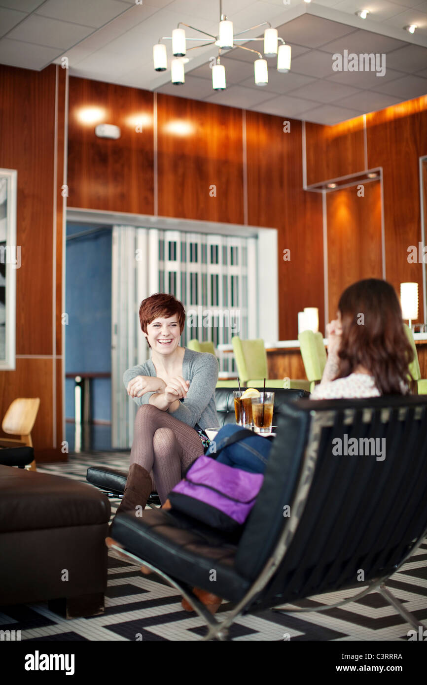 Caucasian friends talking in waiting area Stock Photo - Alamy