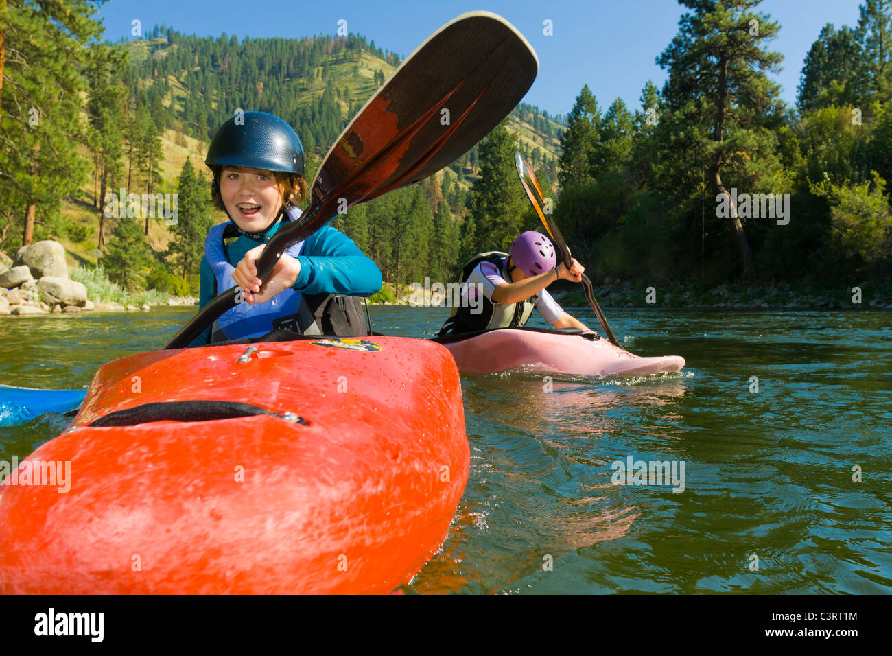 Caucasian girls kayaking in river Stock Photo - Alamy