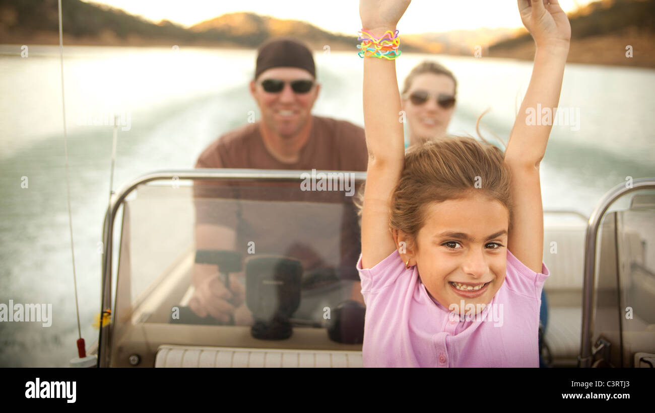 Girl and parents enjoying riding on boat Stock Photo - Alamy