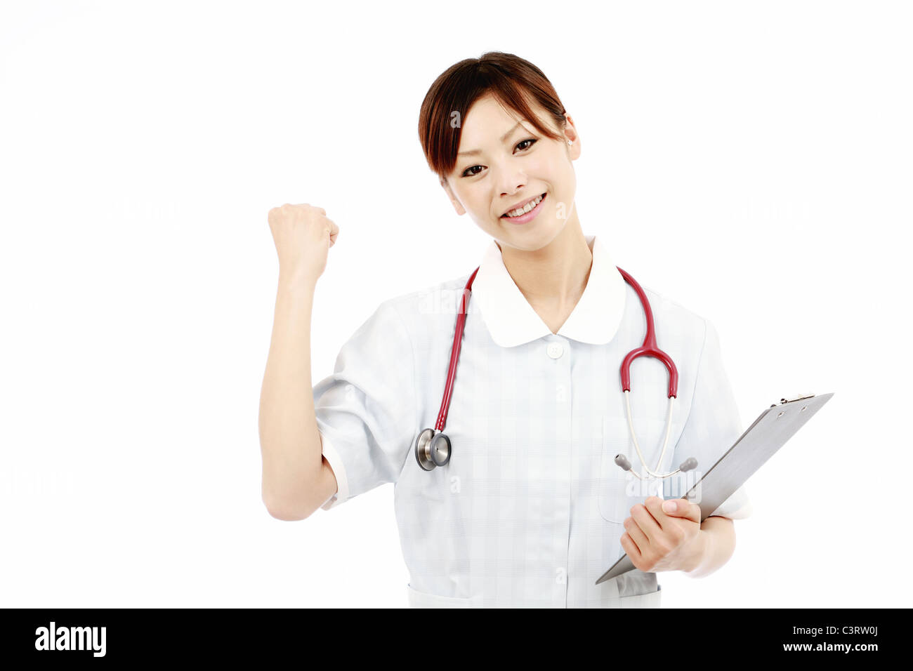 Nurse woman showing arm muscles smiling Stock Photo - Alamy