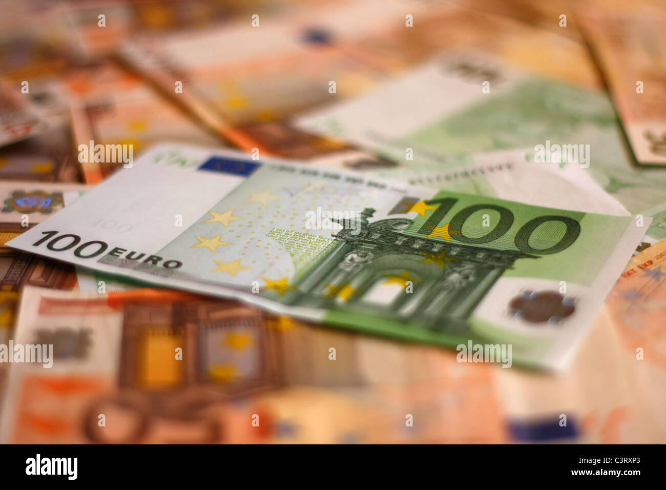 Hundred Euro on Euro background Stock Photo - Alamy
