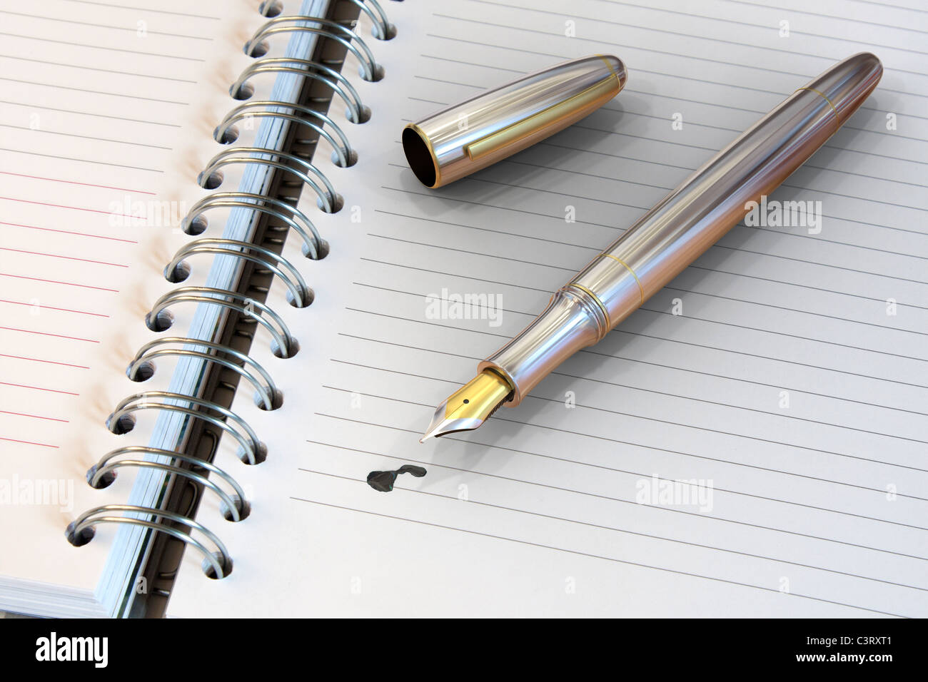 Metal fountain pen on notebook with ink drop Stock Photo - Alamy