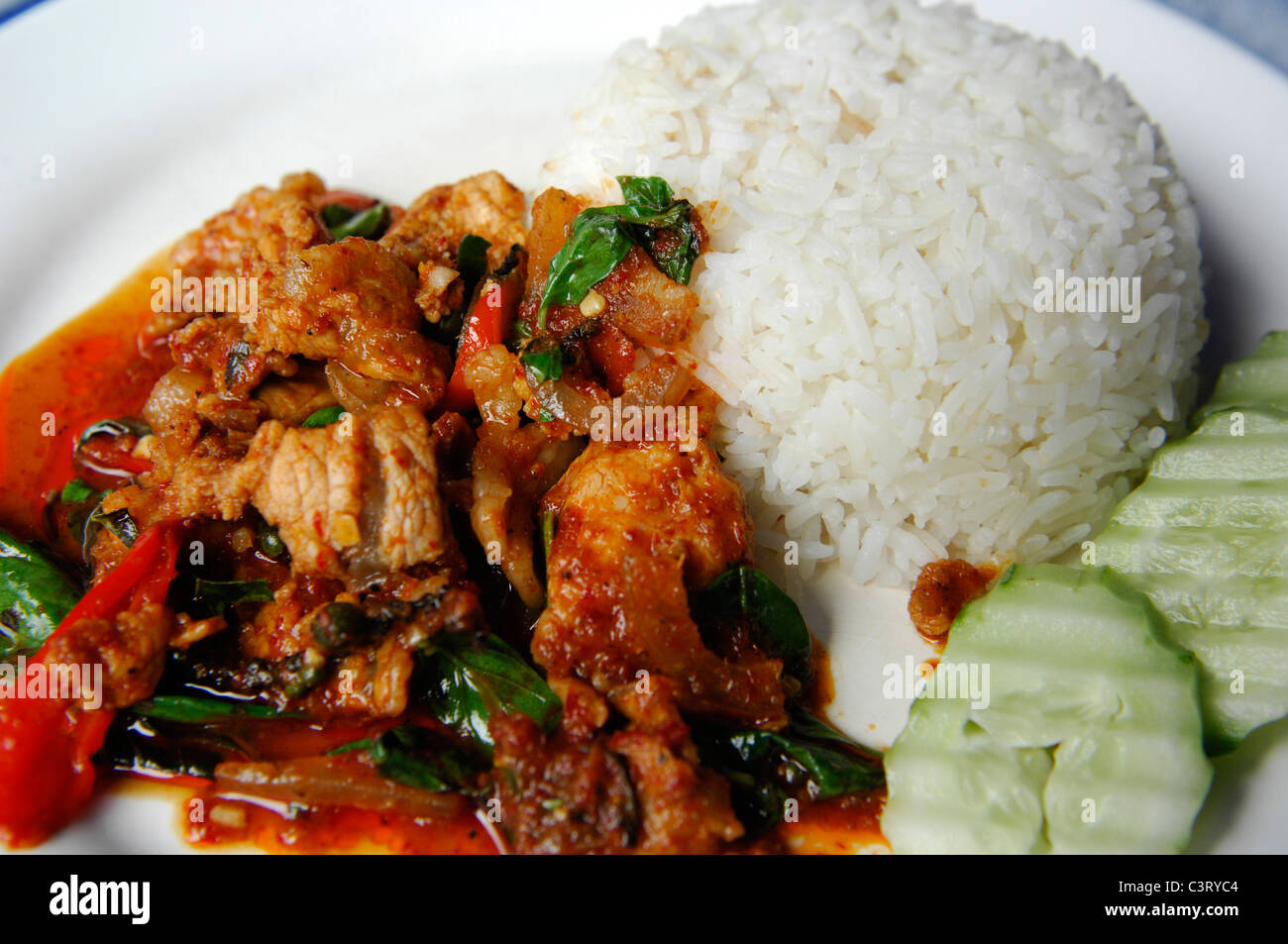 rice served with stir fired pork with red curry paste, thai cuisine ...