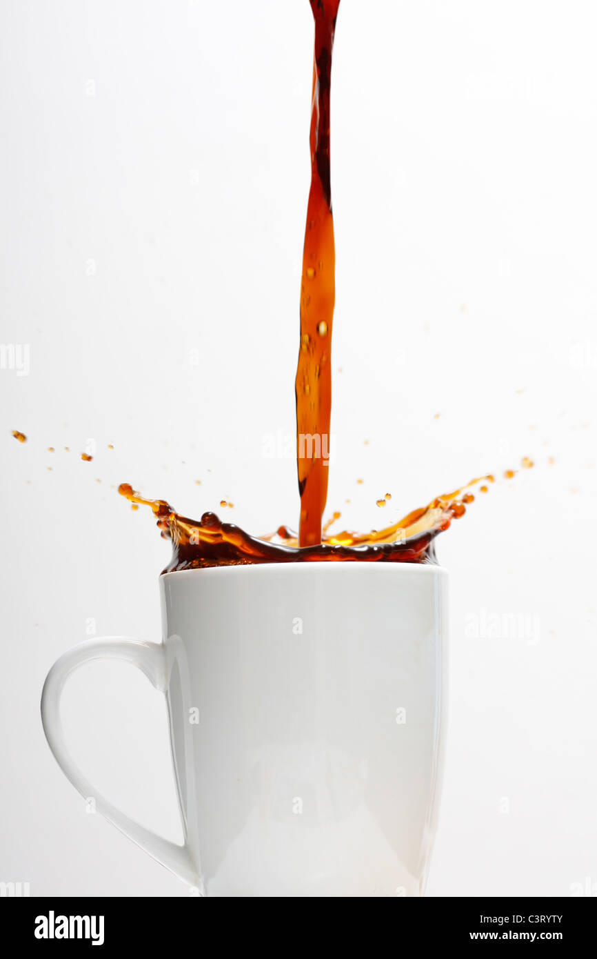 Pouring splashing coffee Stock Photo - Alamy