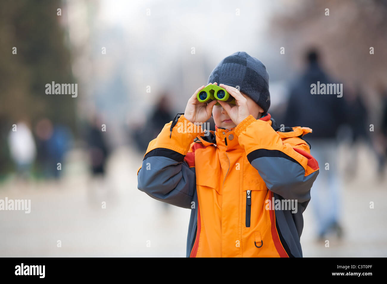 Little boy using binoculars outdoor in an urban environment Stock Photo ...