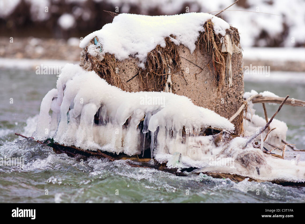 Rock covered in ice in the middle of a river in winter Stock Photo - Alamy
