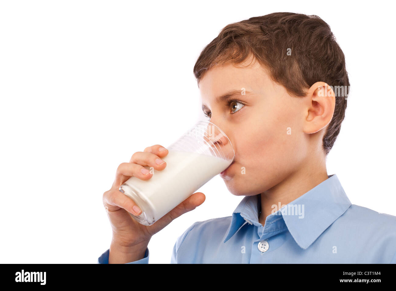 Closeup portrait of a boy drinking a glass of milk, isolated on white ...