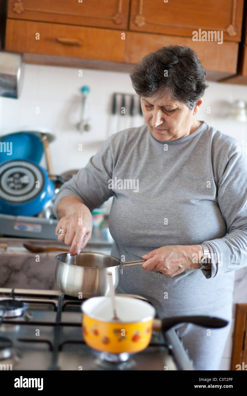 Elderly person cooking on gas stove hi-res stock photography and images ...