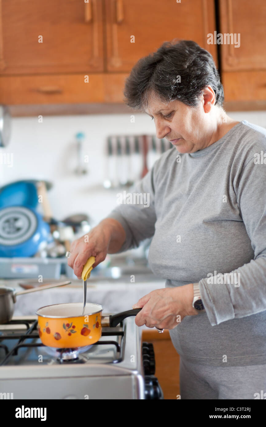 Elderly person cooking on gas stove hi-res stock photography and images ...