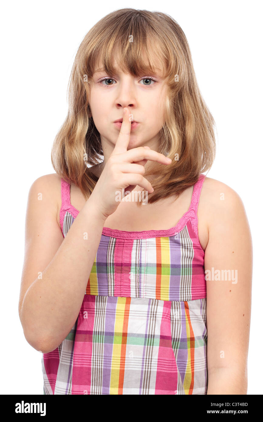 Closeup portrait of a little girl making silence sign with finger on ...