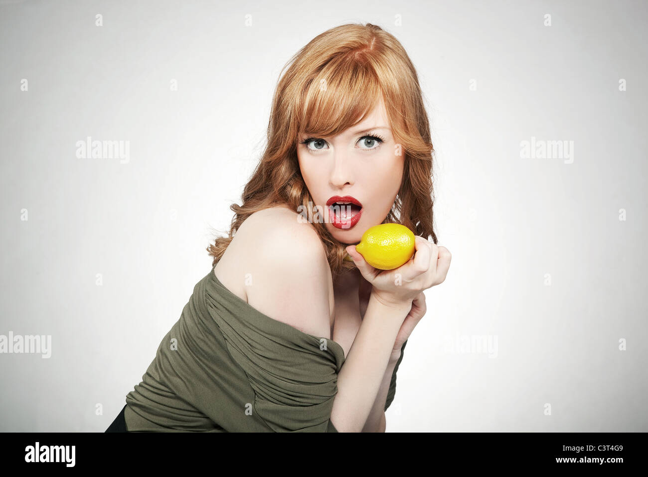 Young beautiful woman holding fruit Stock Photo - Alamy