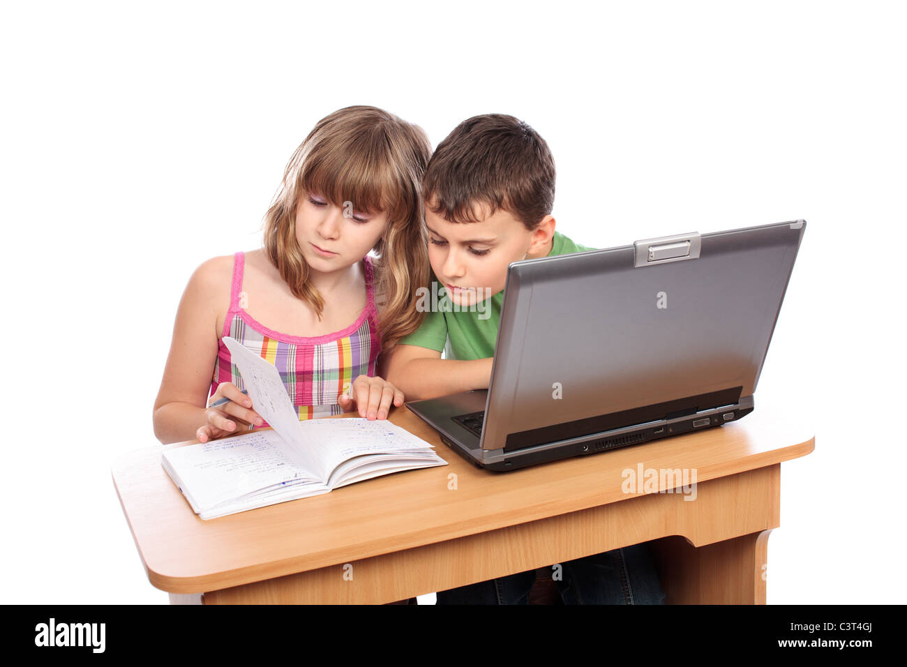 Two school children doing homework together with computer, isolated on ...