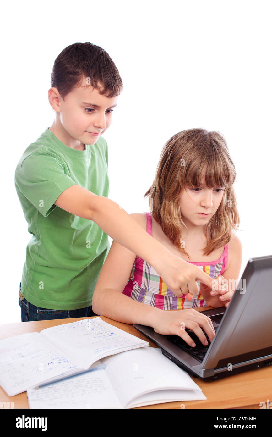 Two school children doing homework together with computer, isolated on ...