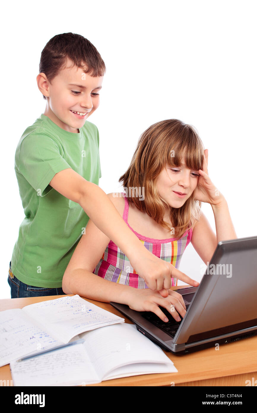 Two school children doing homework together with computer, isolated on ...