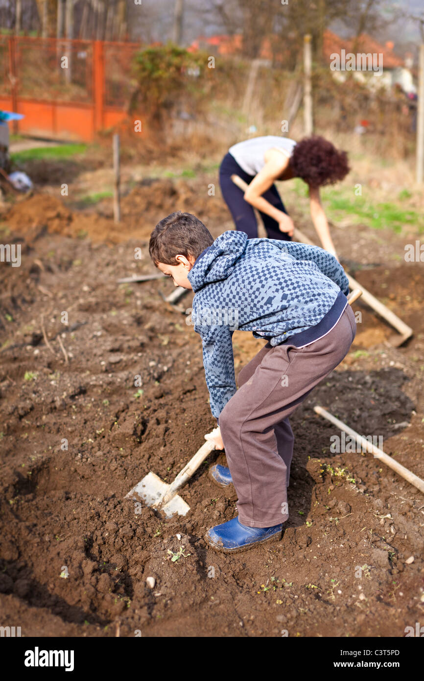 Mother and son digging into the garden for planting trees Stock Photo ...