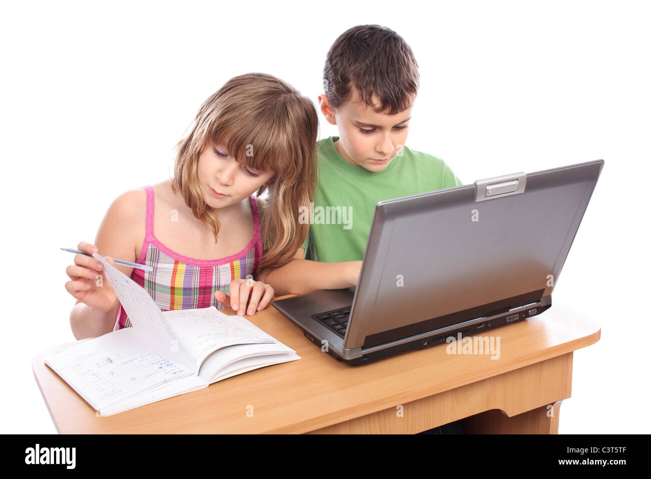 Two school children doing homework together with computer, isolated on ...