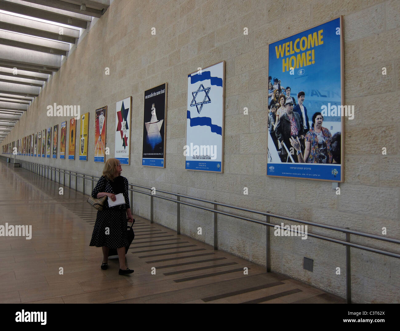 A passenger walks past graphic posters depicting Israel motif at the ...