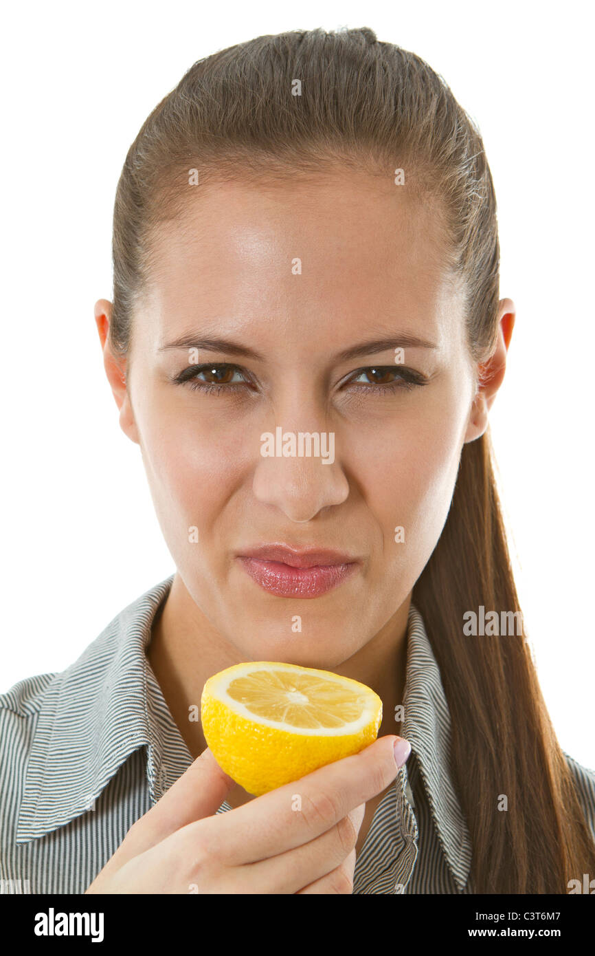 Young woman eating a lemon, make a grimace Stock Photo - Alamy