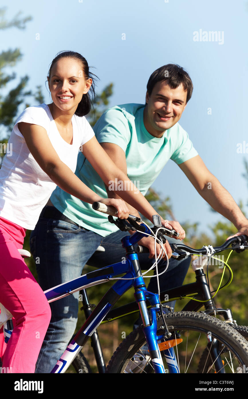 Portrait of two young people on bikes Stock Photo - Alamy