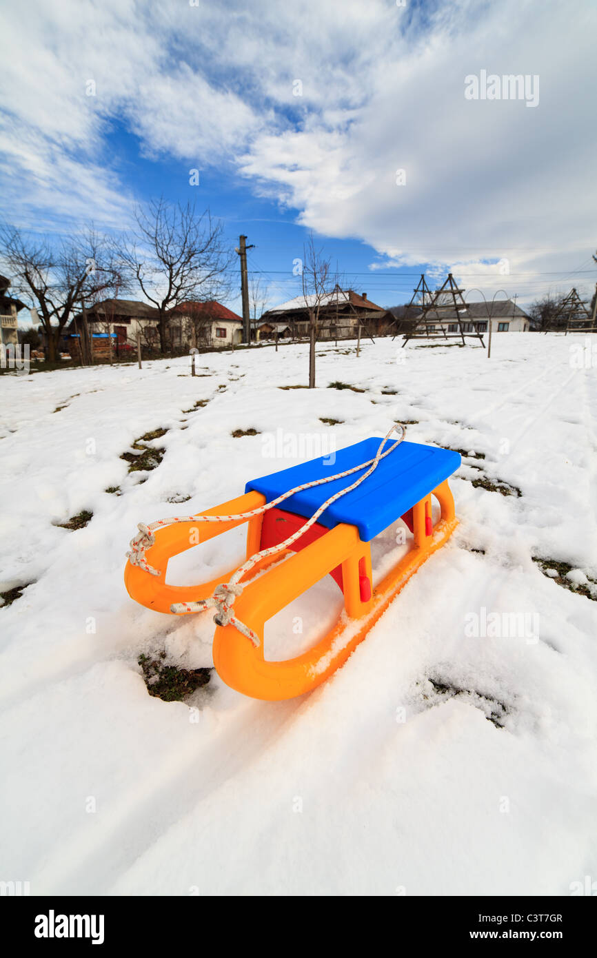 Countryside view with a plastic yellow and blue sledge Stock Photo - Alamy