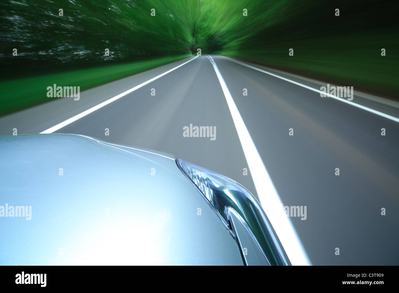 car driving fast into forest Stock Photo - Alamy