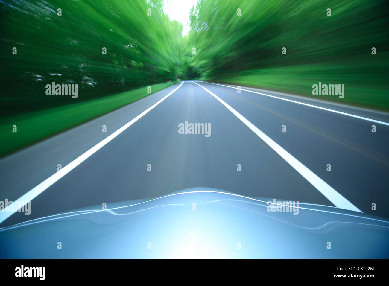 car driving fast into forest Stock Photo - Alamy