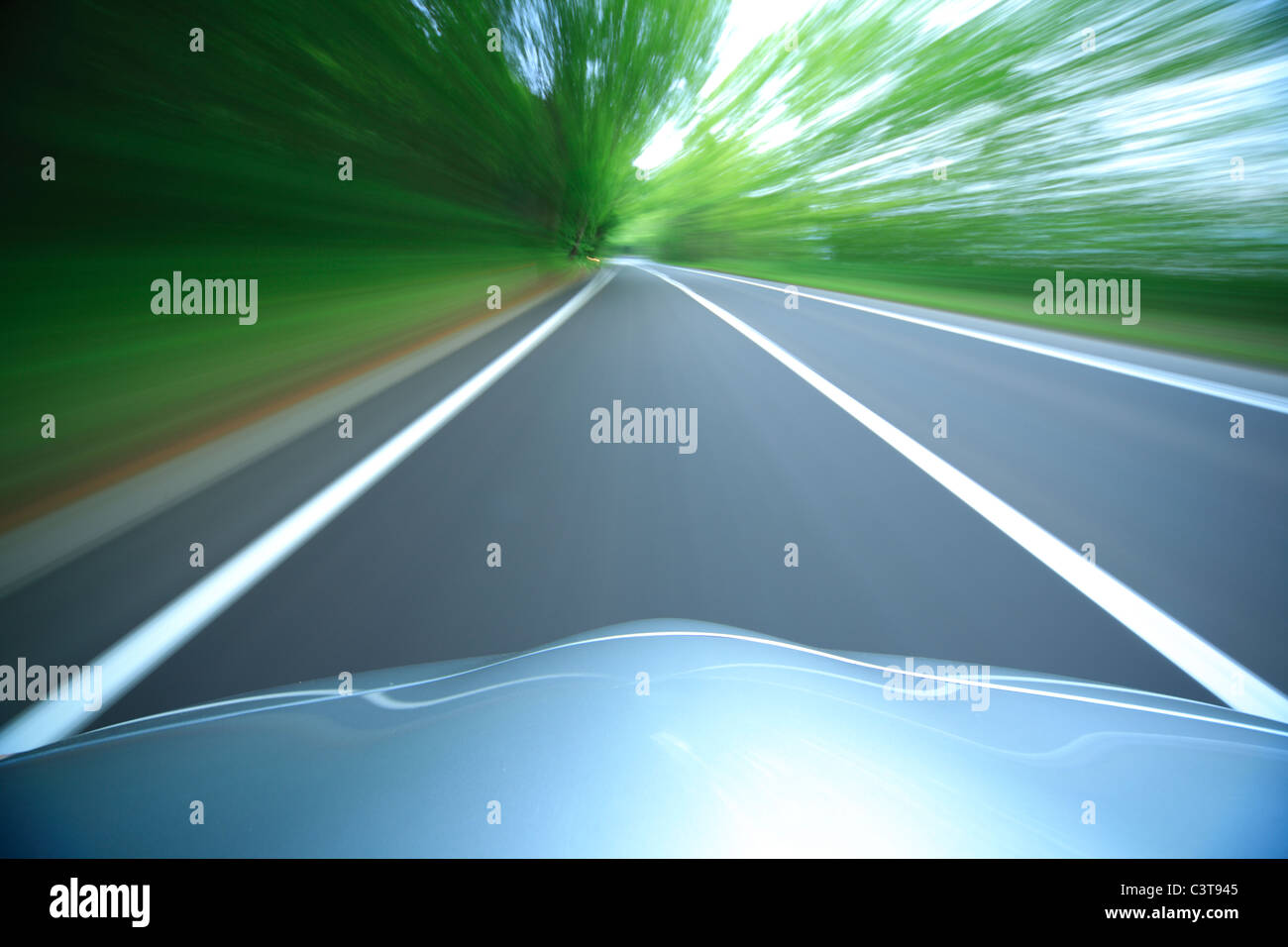 car driving fast into forest Stock Photo - Alamy